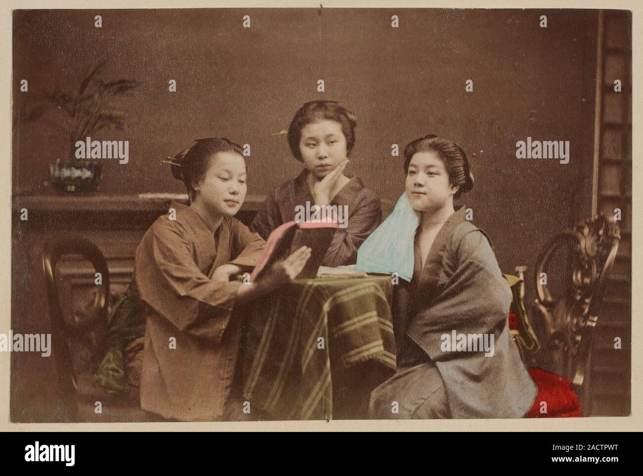 Photograph of three Japanese women reading Stock Photo - Alamy