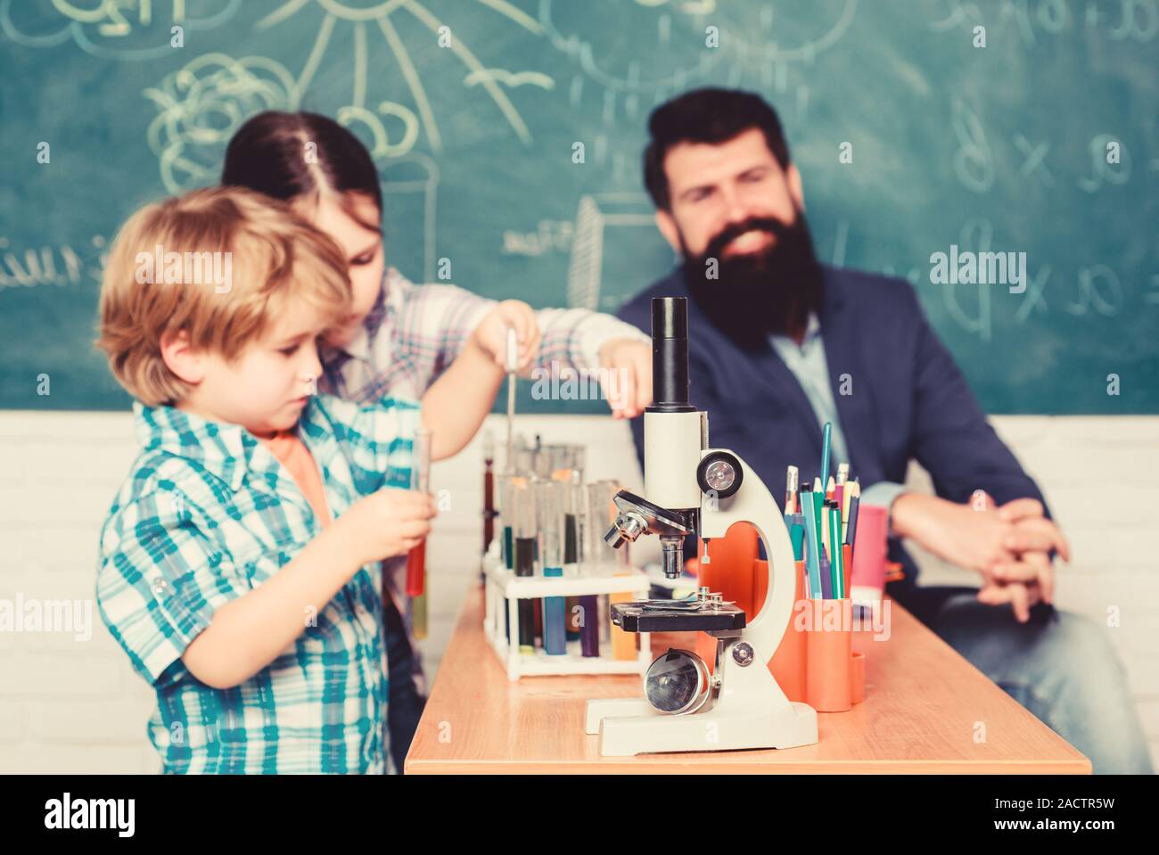 students doing science experiments with microscope in lab. back to ...