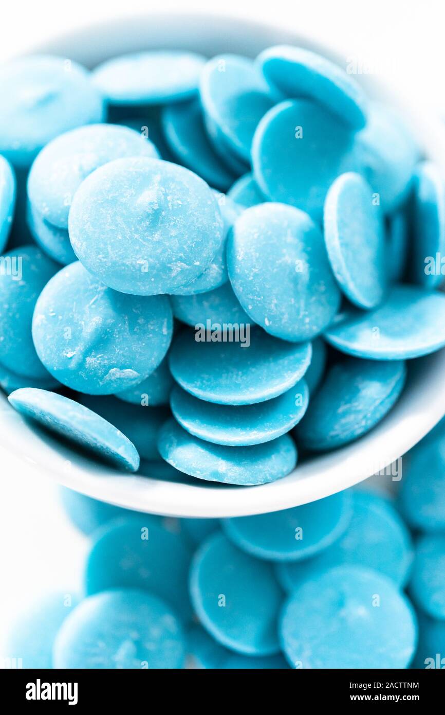 Blue round chocolate chips for melting chocolate shapes Stock Photo - Alamy