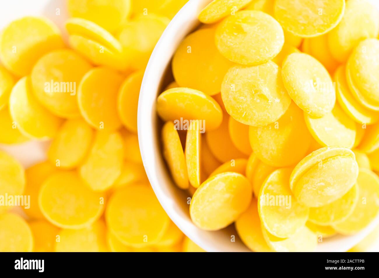 Yellow round chocolate chips for melting chocolate shapes Stock Photo ...
