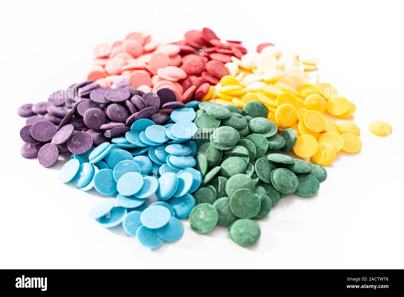Rainbow colors of round chocolate chips for melting chocolate shapes on ...