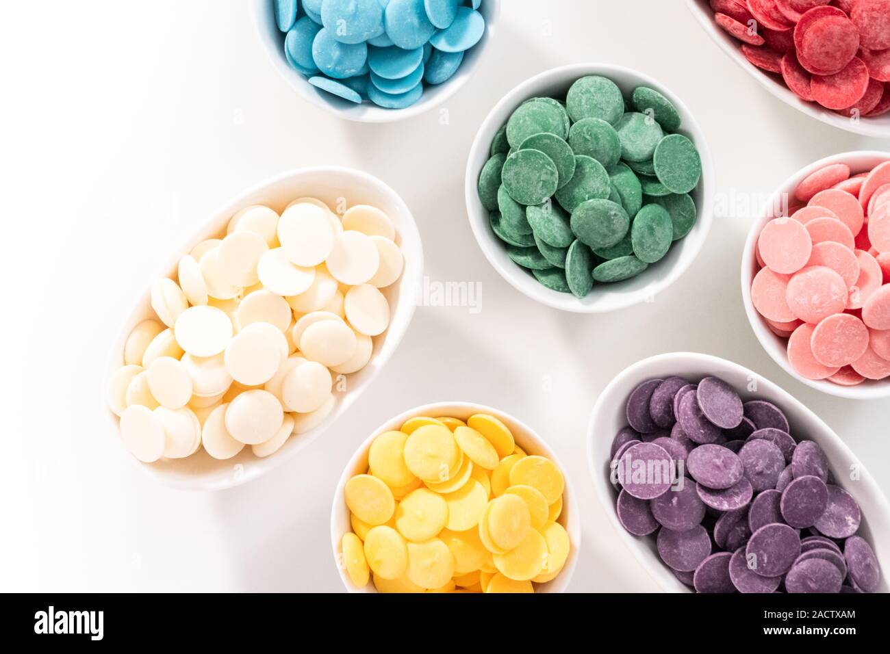 Flat lay. Pink round chocolate chips for melting chocolate shapes on a ...