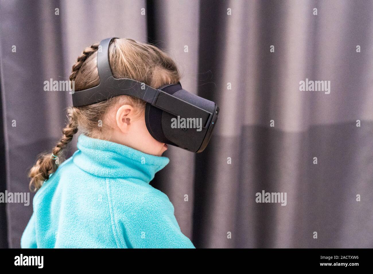 Little girl playing VR kids game in the living room Stock Photo - Alamy