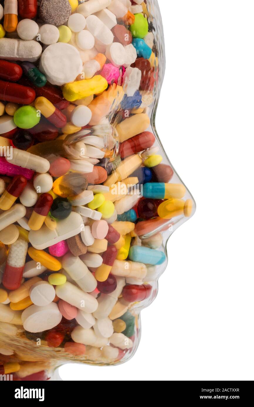 Glass head with tablets Stock Photo - Alamy