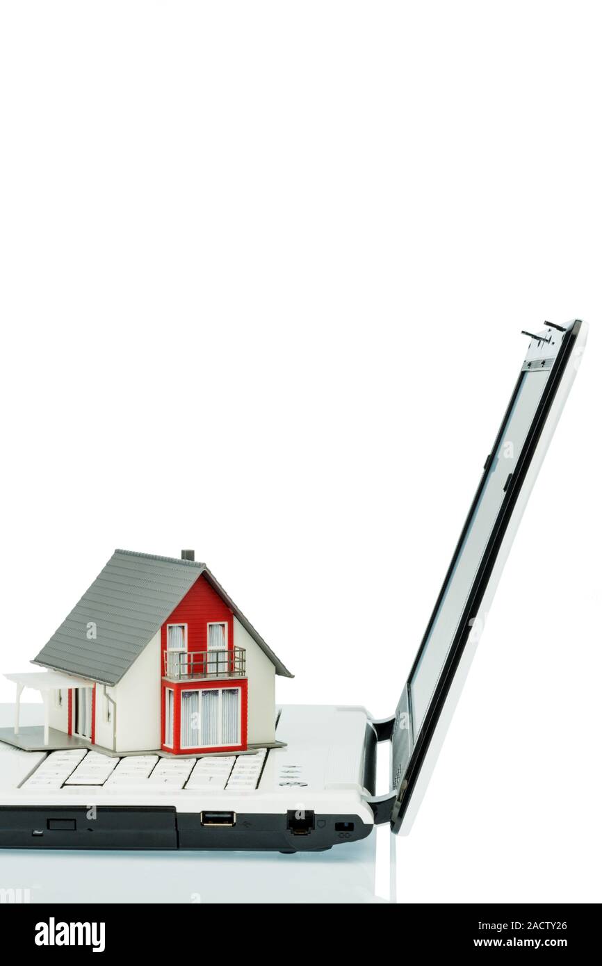 Residential house on computer keyboard Stock Photo - Alamy