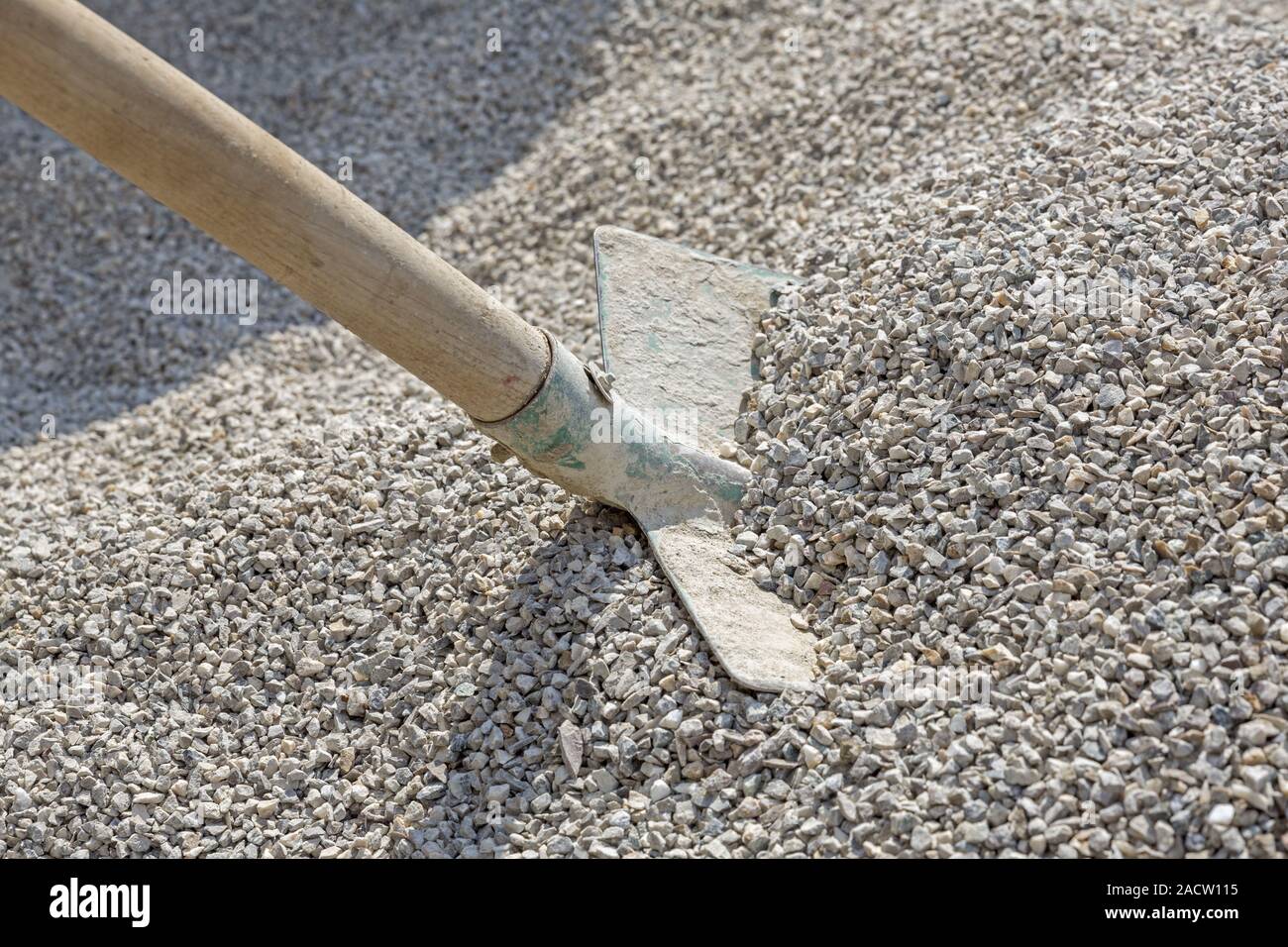 Bucket in rolled chippings Stock Photo - Alamy