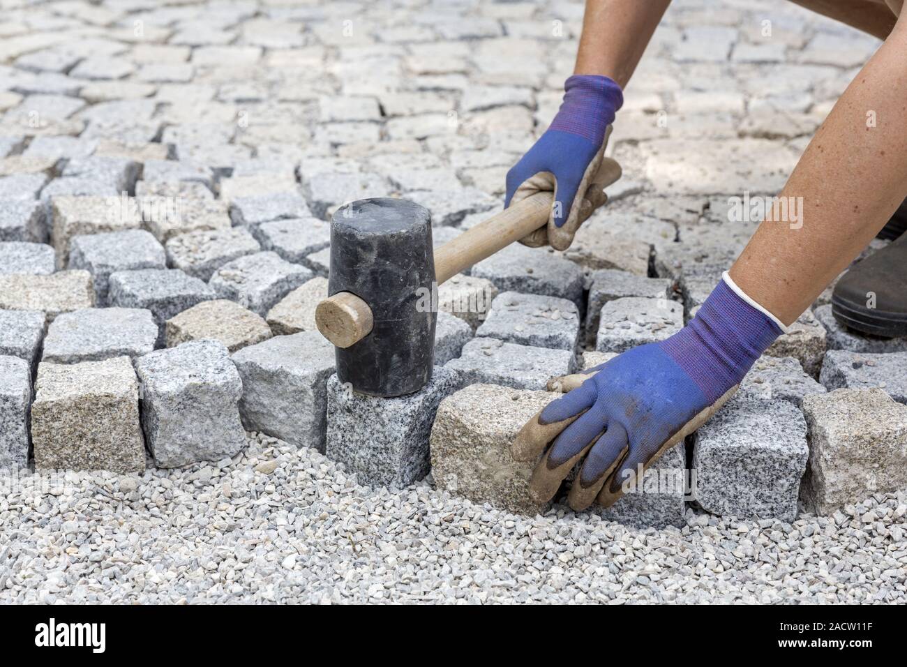 Laying granite stones Stock Photo - Alamy