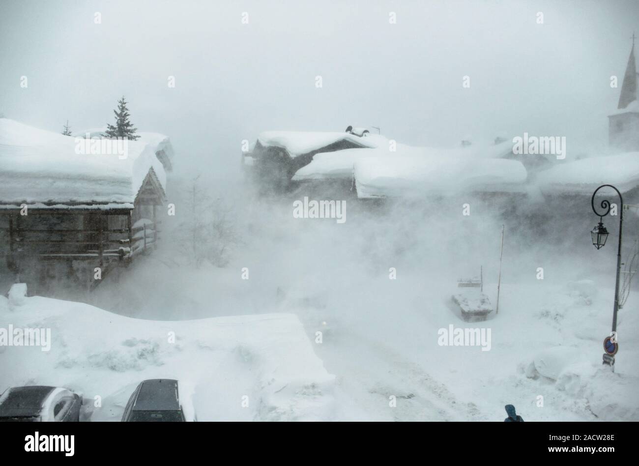 Snow storm at Val d'Isere, Savoie of France. Buildings covered with ...