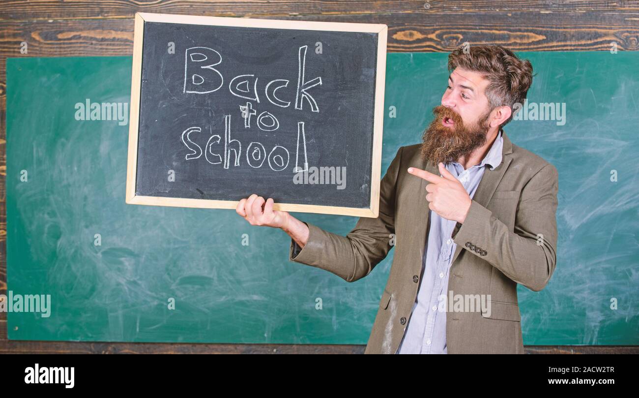 Hiring teachers for new school year. Man bearded holds blackboard ...