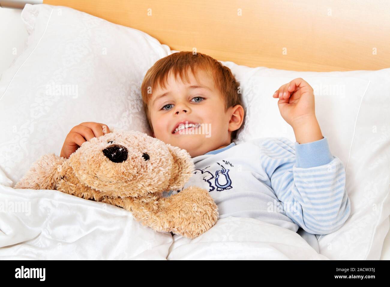 Child lying in bed in bedroom Stock Photo - Alamy
