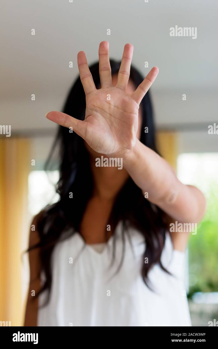defensive attitude of a woman Stock Photo - Alamy