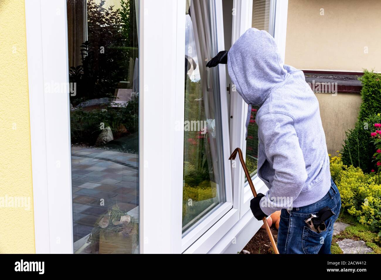 Burglar at a window Stock Photo - Alamy