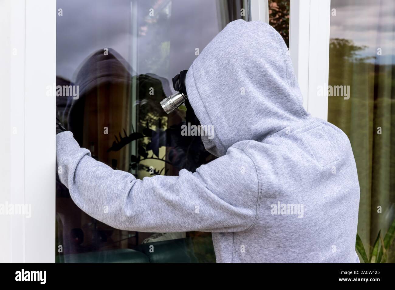 Burglar at a window Stock Photo - Alamy