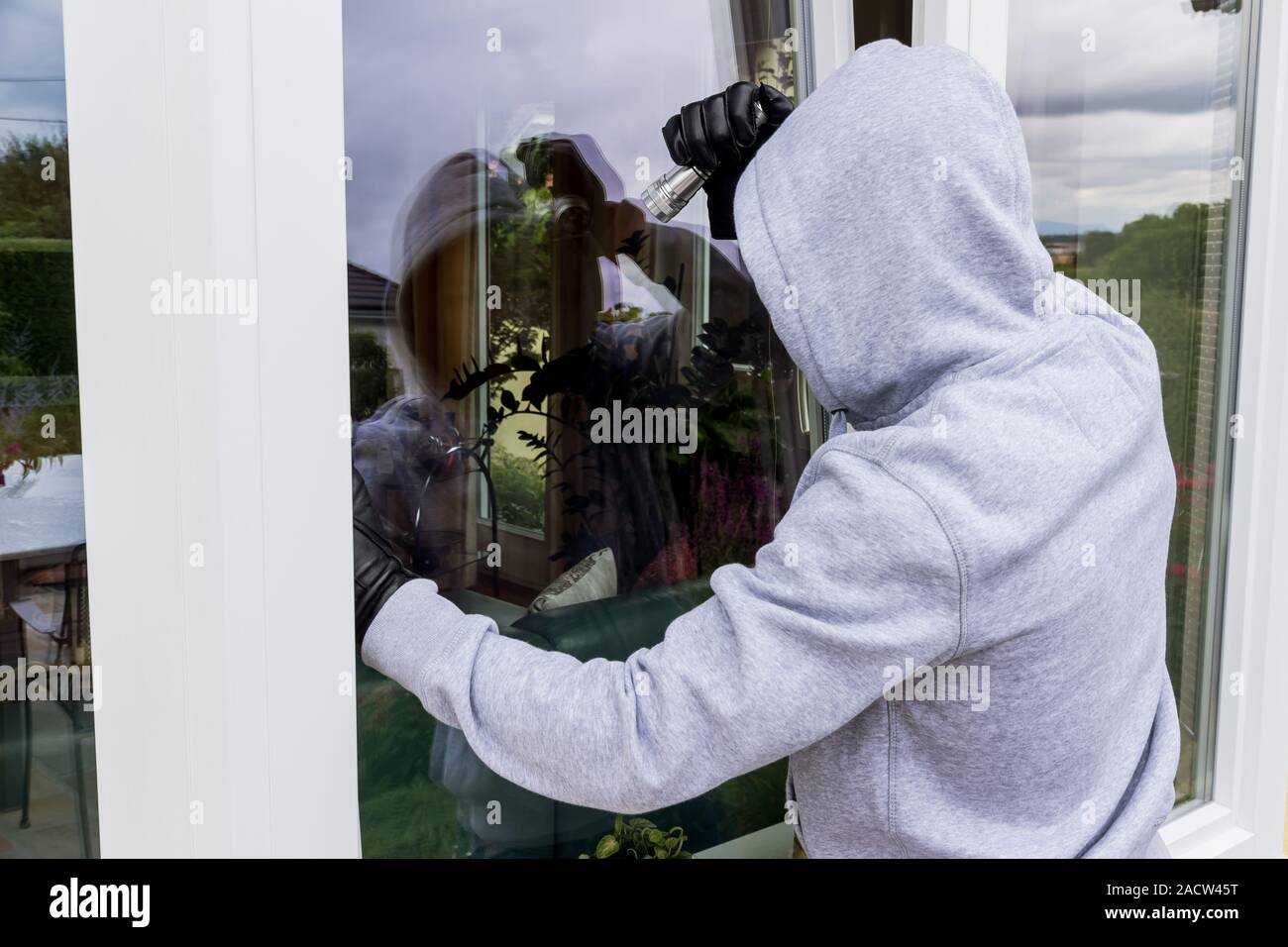 Burglar at a window Stock Photo - Alamy