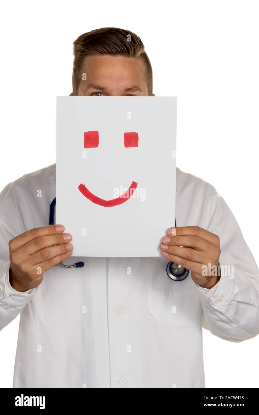 Doctor holds smiley in front of face Stock Photo - Alamy