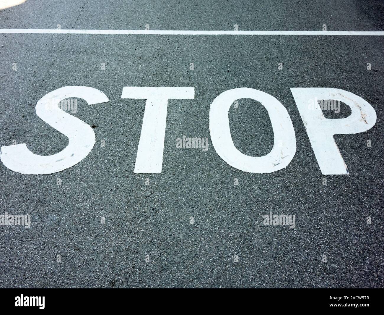 STOP inscription on a road Stock Photo - Alamy