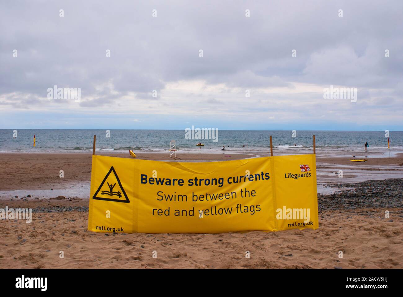 Royal National Lifeboat Institution (RNLI) sign on Welsh beach warning ...