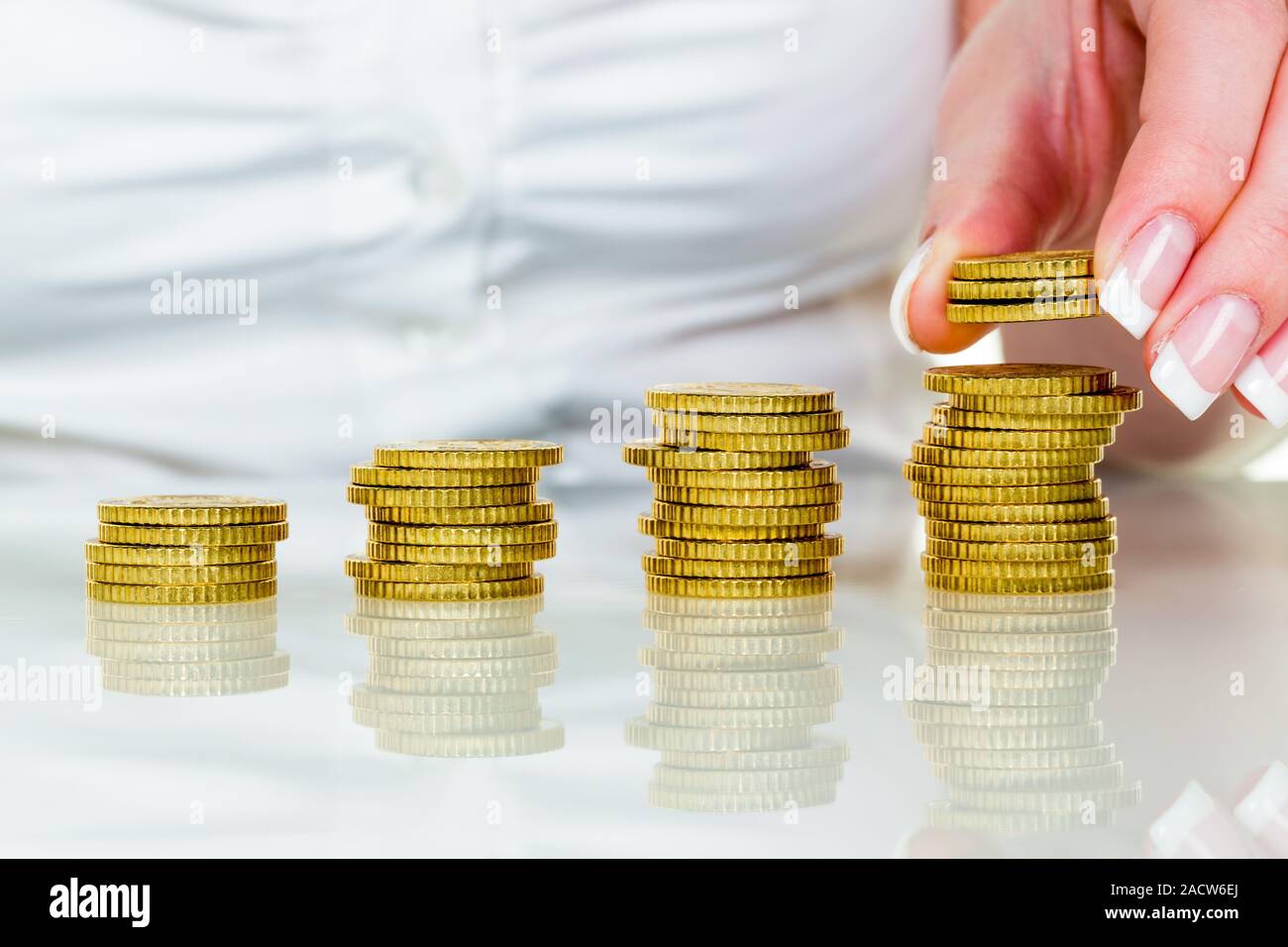Woman coin stack saving hi-res stock photography and images - Alamy
