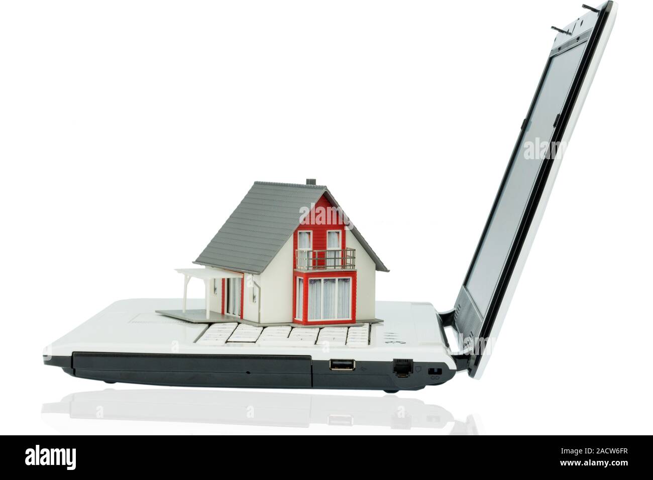 Residential house on computer keyboard Stock Photo - Alamy