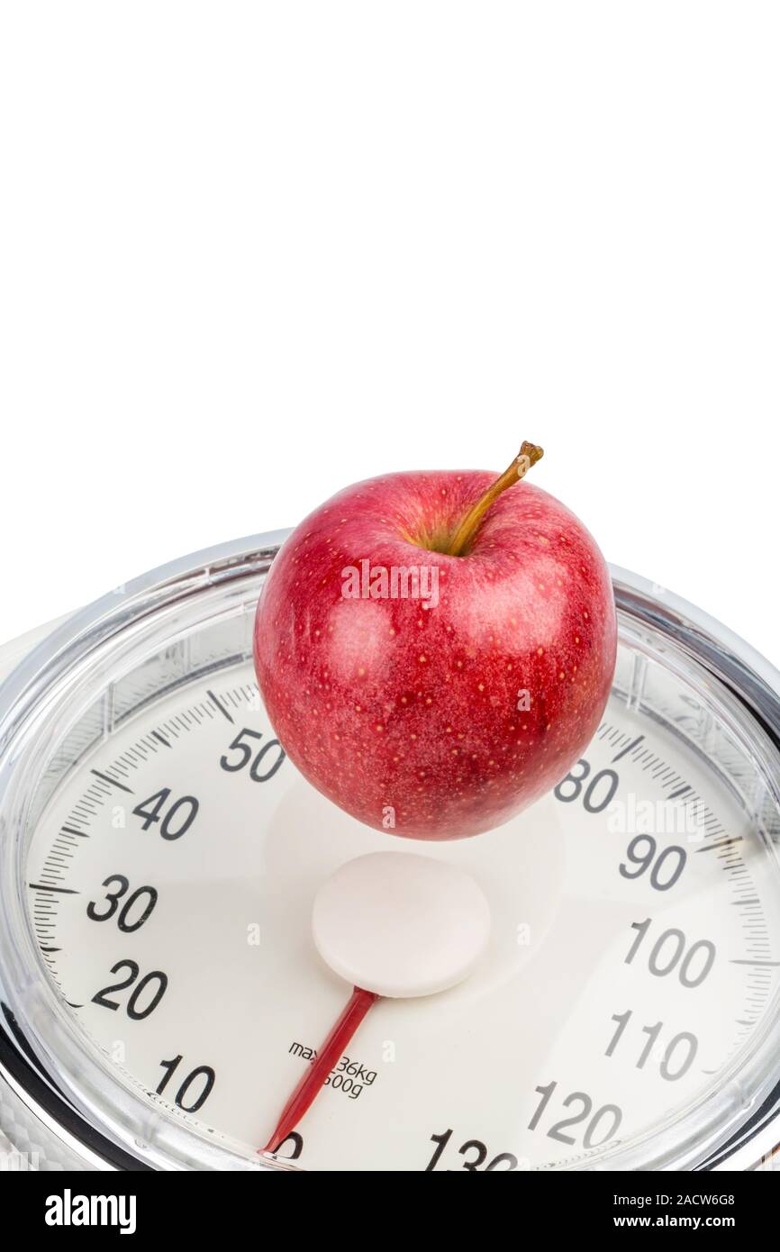 Apple lies on a scale Stock Photo - Alamy