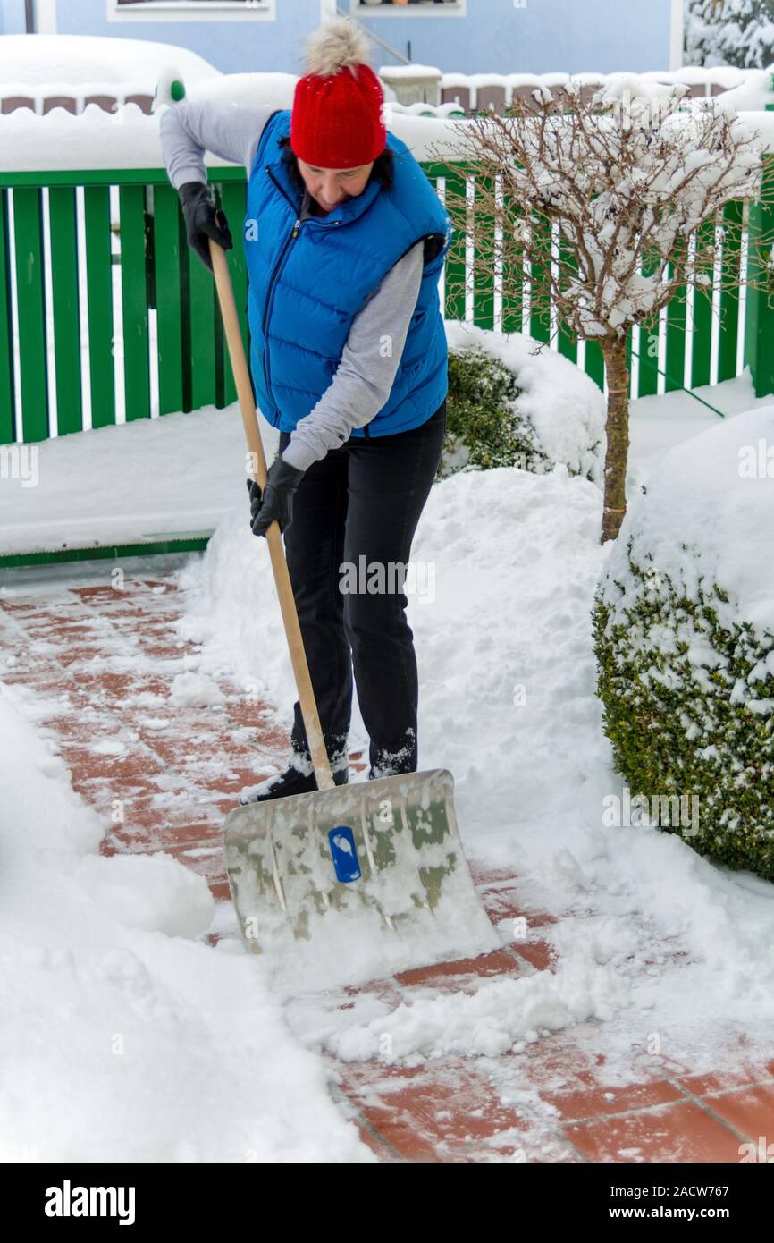 Woman shoveling snow hi-res stock photography and images - Alamy