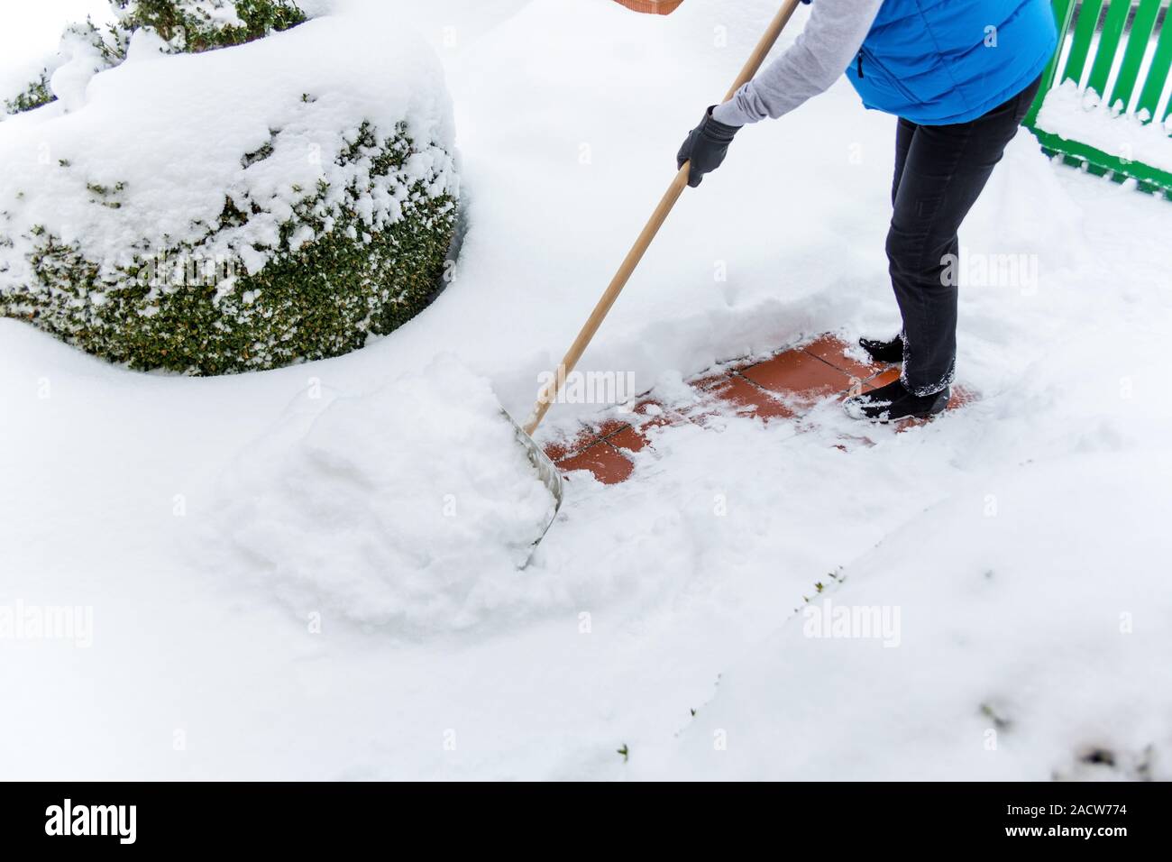Woman shoveling snow Stock Photo - Alamy