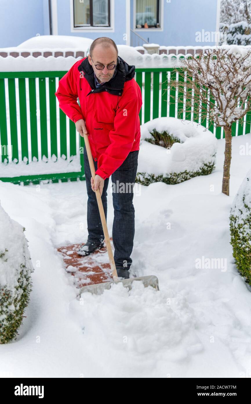 Man shoveling snow Stock Photo - Alamy