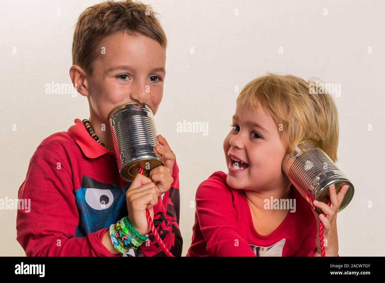 Children with a box telephone Stock Photo - Alamy