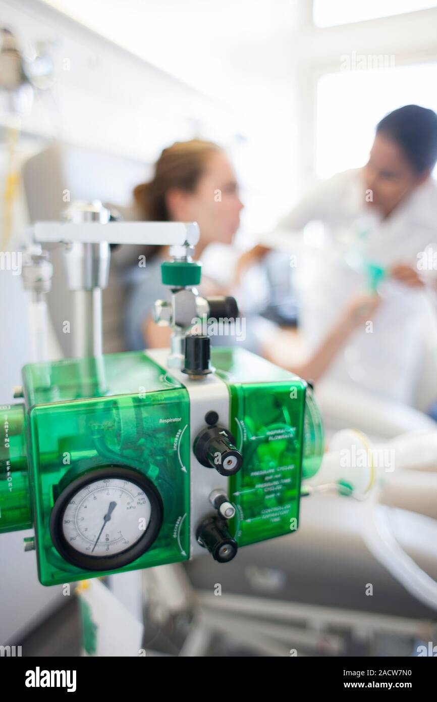 IPPB therapy for cystic fibrosis. Physiotherapist using an intermittent ...