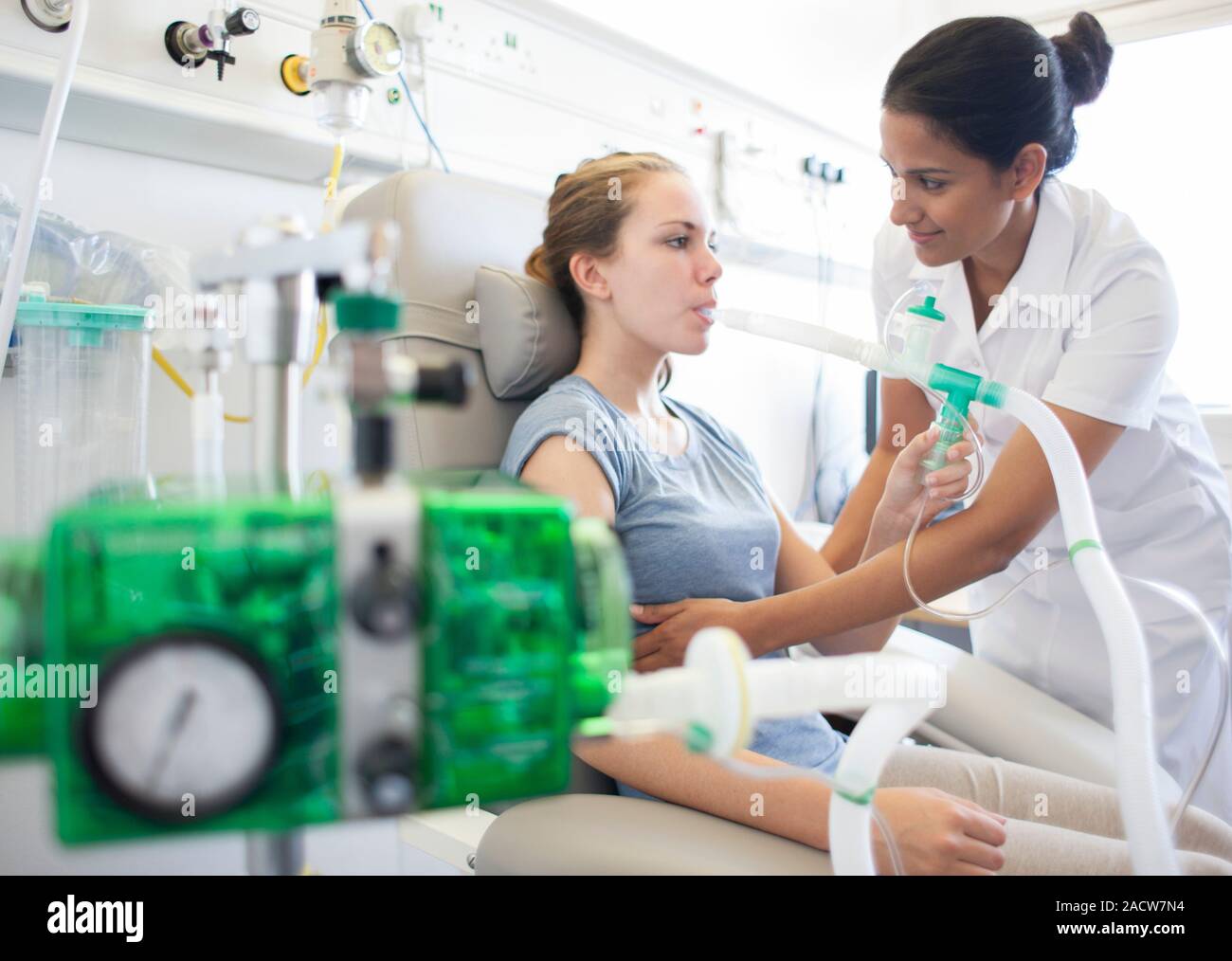 IPPB therapy for cystic fibrosis. Physiotherapist using an intermittent ...