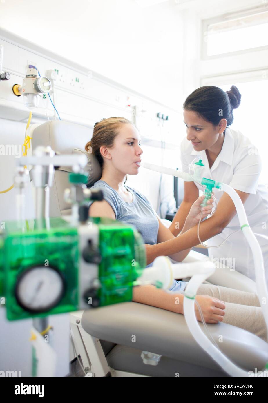 IPPB therapy for cystic fibrosis. Physiotherapist using an intermittent ...