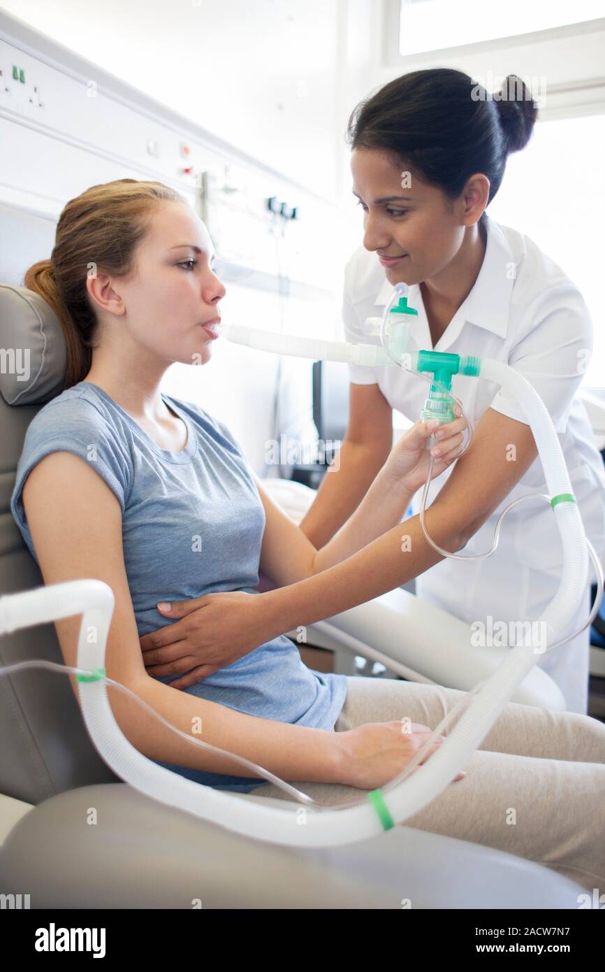 IPPB therapy for cystic fibrosis. Physiotherapist using an intermittent ...