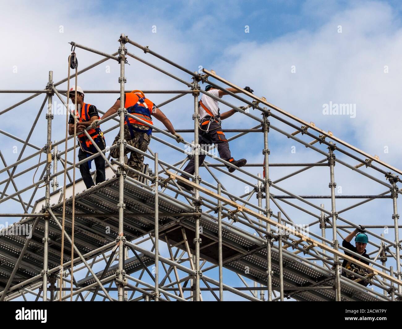 Construction worker on a scaffold Stock Photo - Alamy