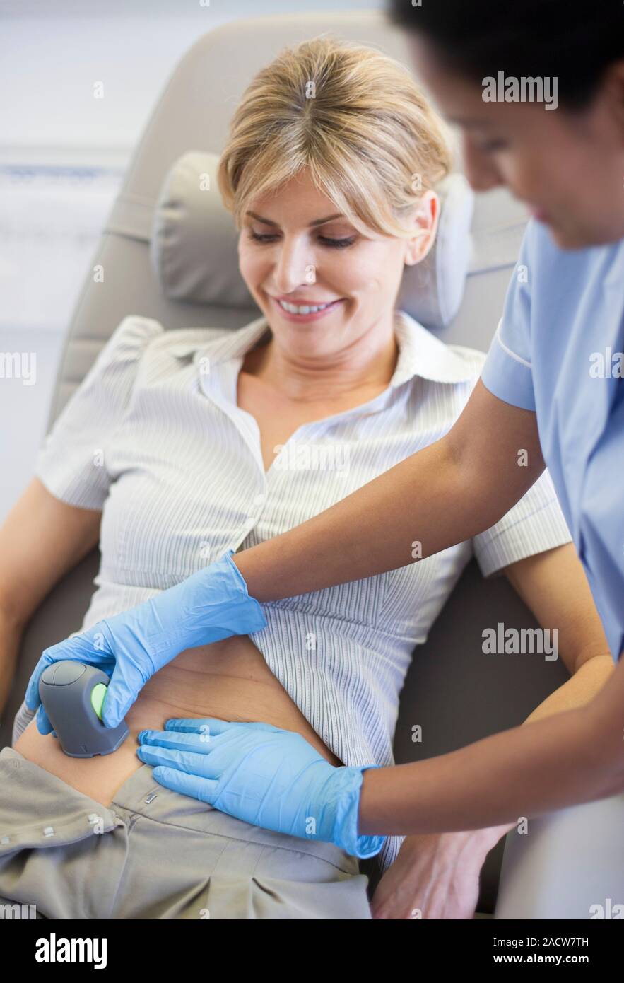 Continuous glucose monitoring. Nurse inserting a continuous glucose ...