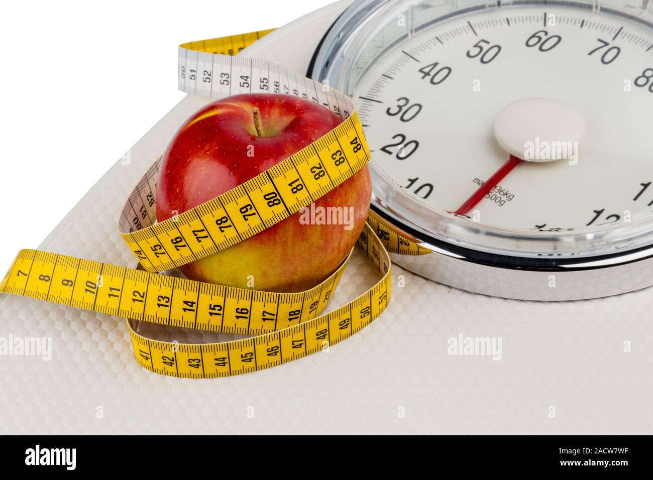 Apple lies on a scale Stock Photo - Alamy