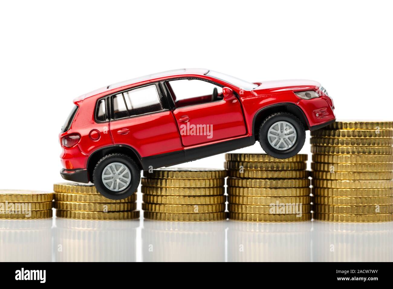 Car on coins Stock Photo - Alamy