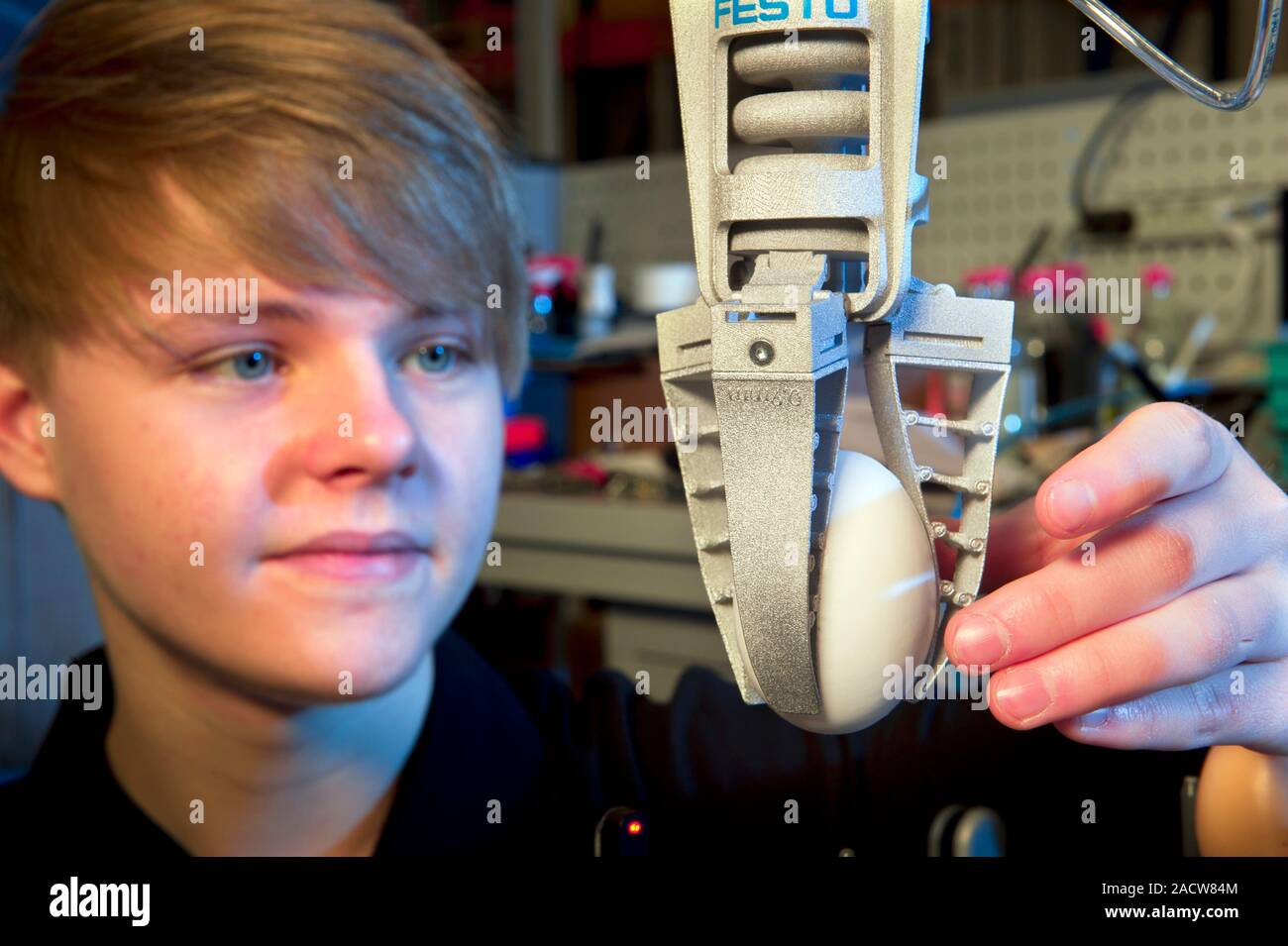 Bionic Tripod. Boy using a Bionic Tripod to grip an egg without breaking it. Bionic Tripod is an ...