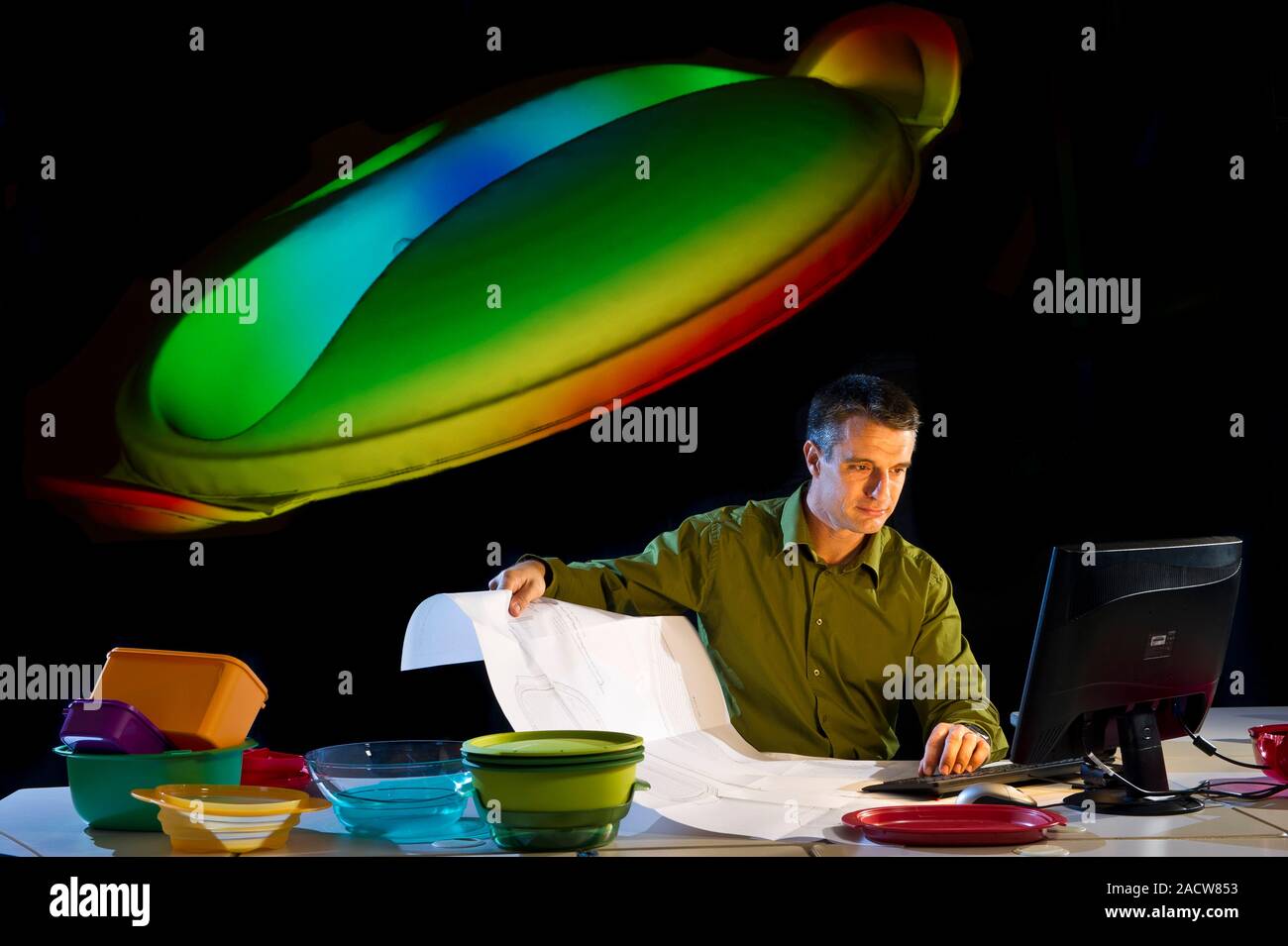 Tupperware factory. Product designer reviewing items made in a factory ...