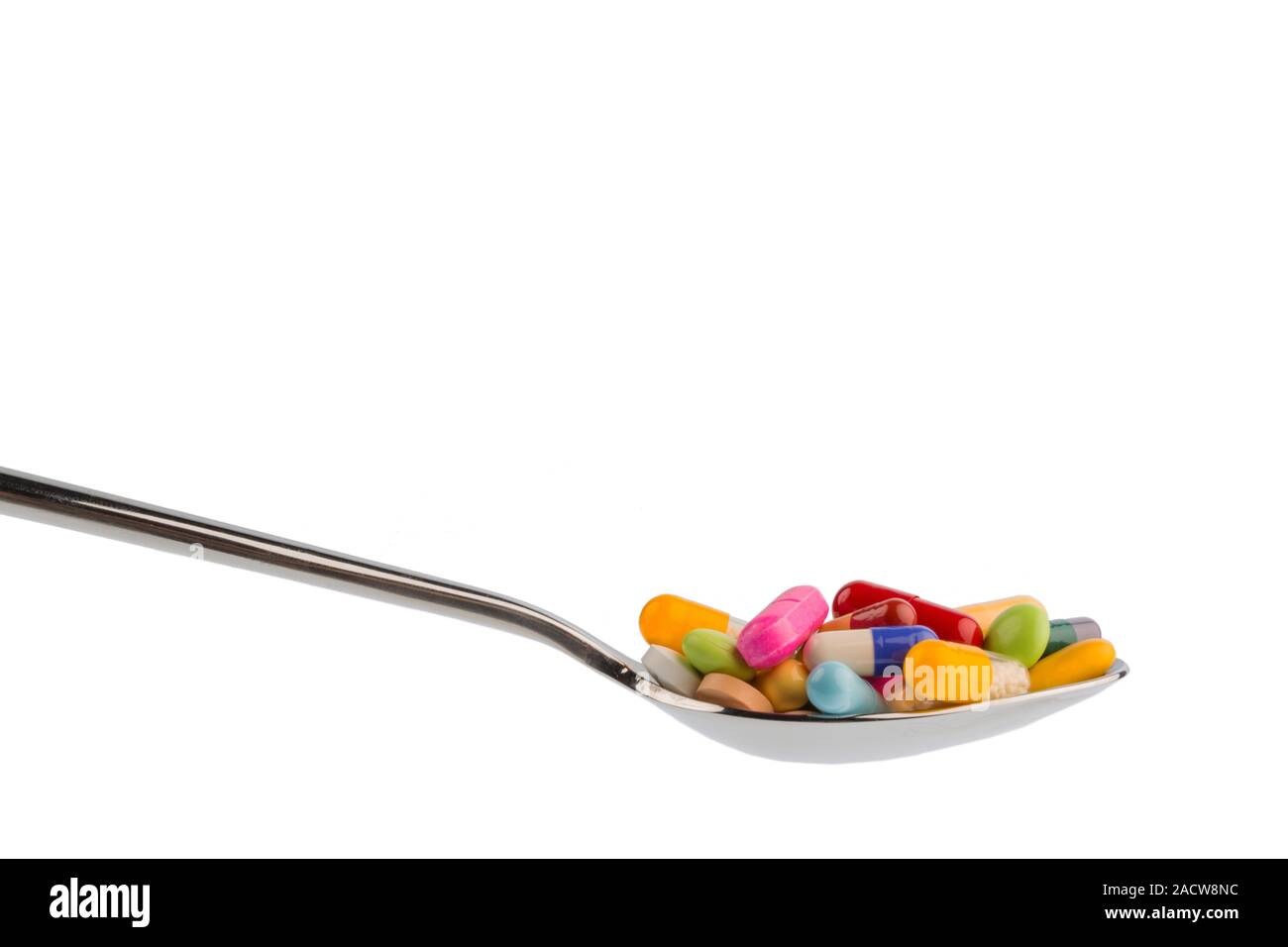 Many tablets on spoon Stock Photo - Alamy