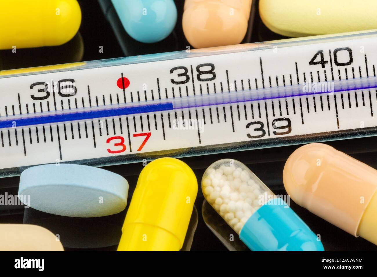 Fever thermometers and tablets Stock Photo - Alamy