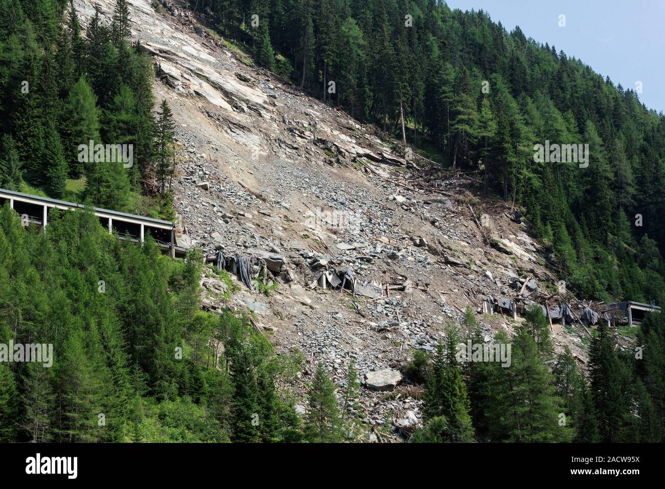 Landslide damage, Austrian Alps. Debris and treeless area on a ...