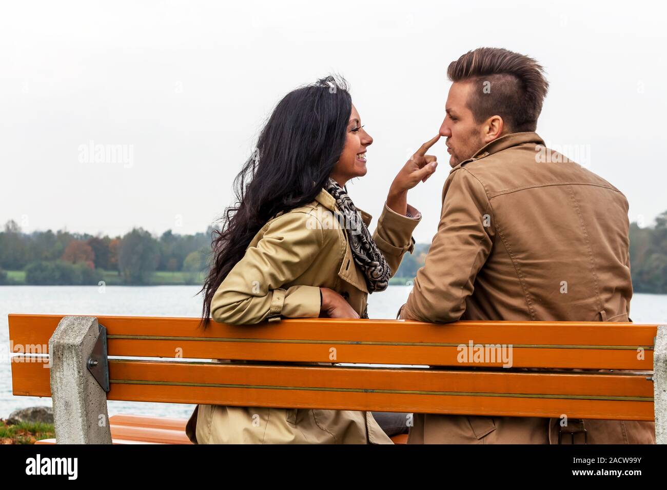 Couple in love on a park bench Stock Photo - Alamy