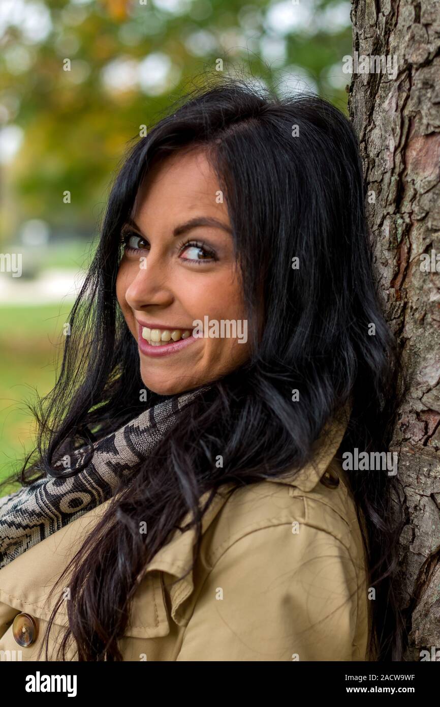 Young woman with tree Stock Photo - Alamy