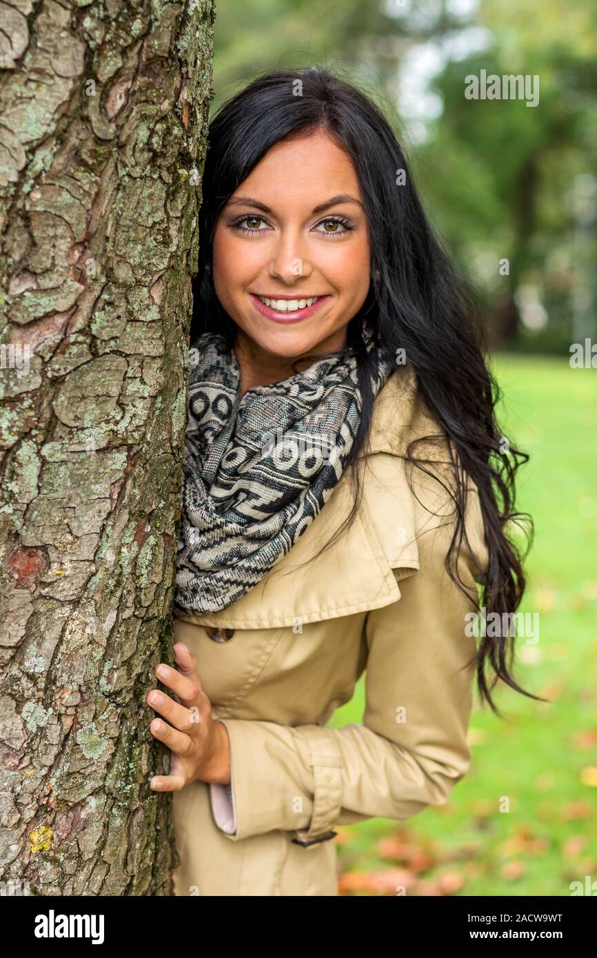Young woman with tree Stock Photo - Alamy