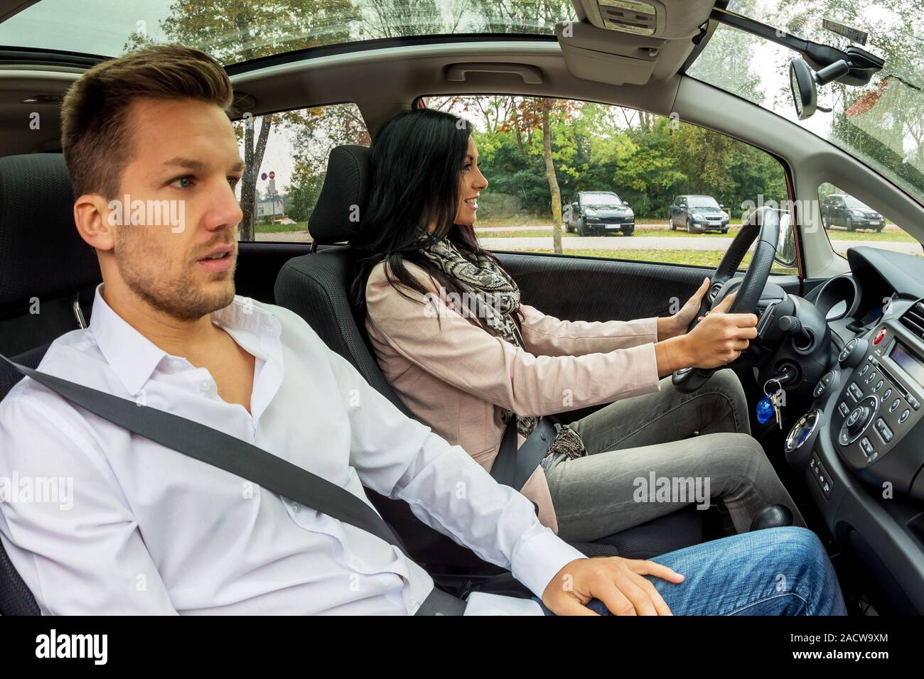 Couple driving in a car Stock Photo - Alamy