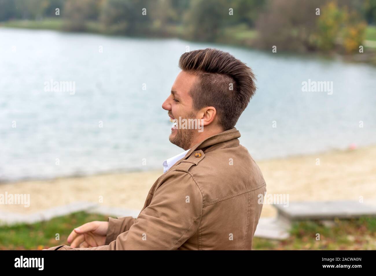Man leaning against tree Stock Photo - Alamy