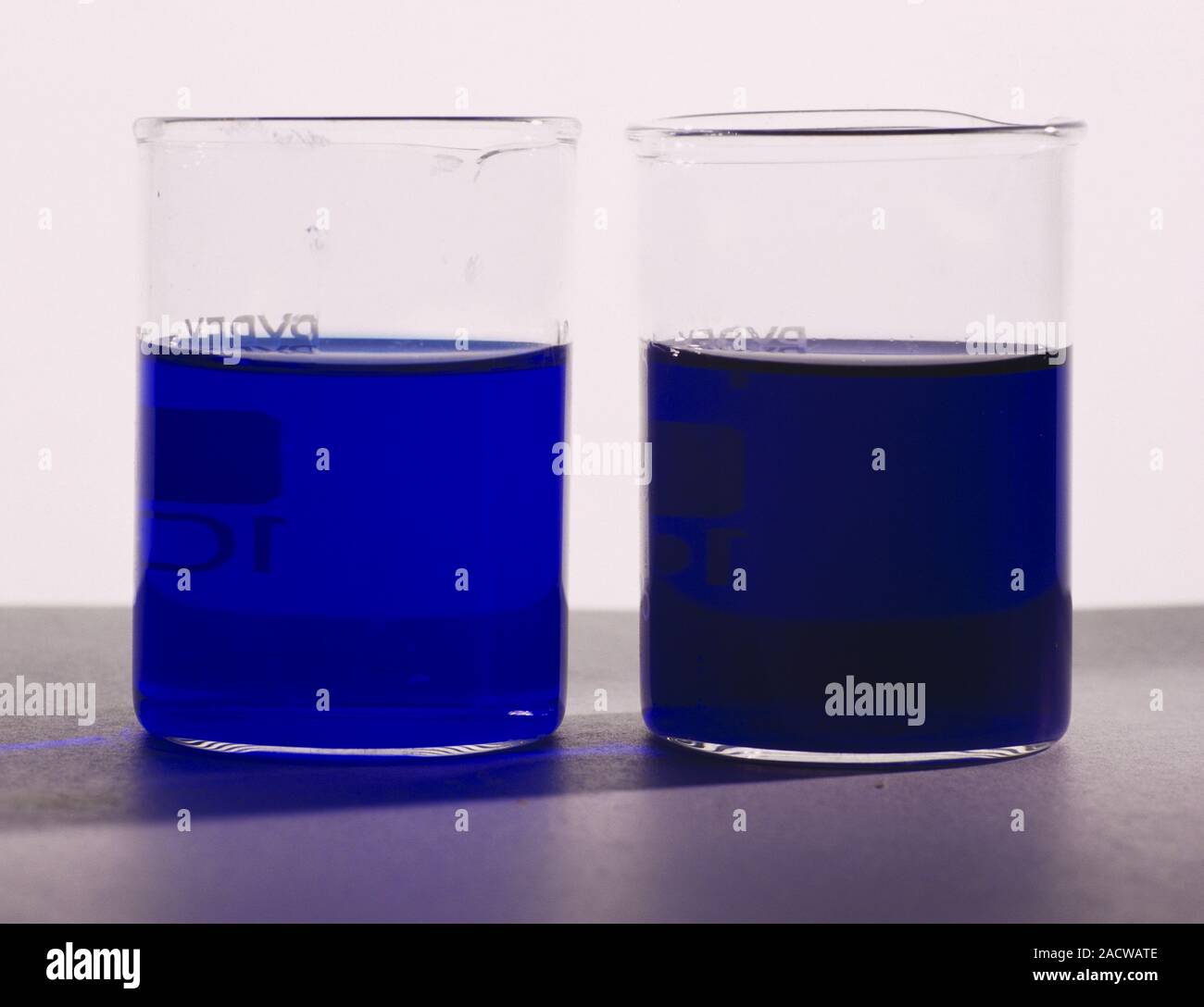 Copper (II) reaction. Two beakers containing solutions of copper (II ...