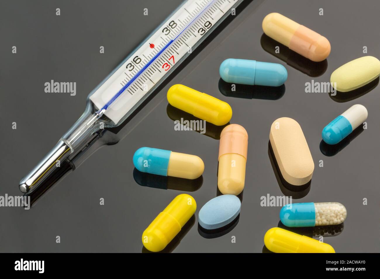 Fever thermometers and tablets Stock Photo - Alamy