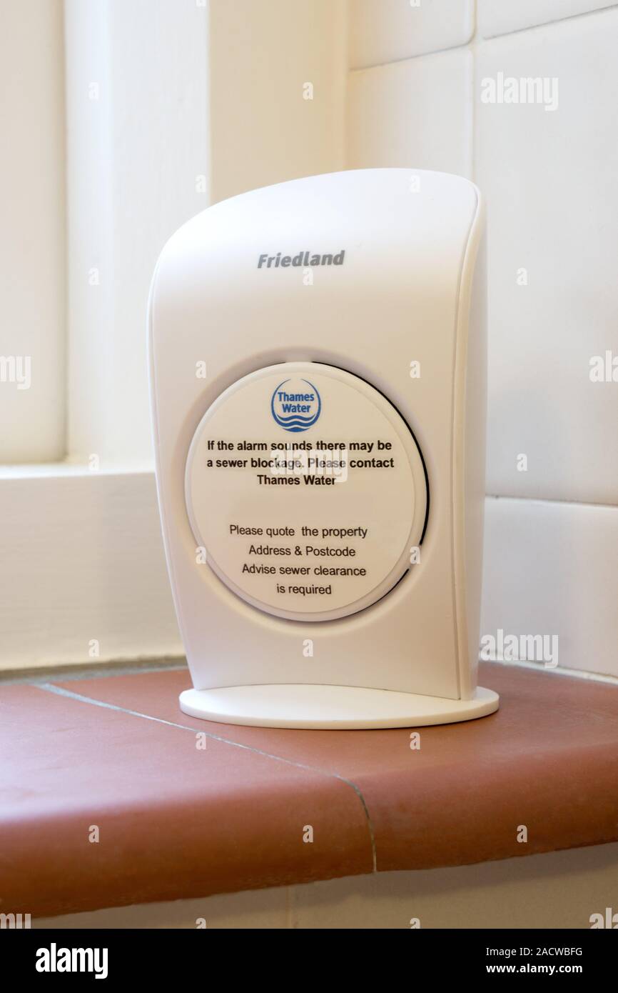 Sewer alarm monitor situated inside a domestic property and connected ...