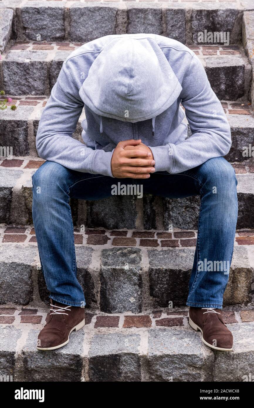 Man sitting on steps Stock Photo - Alamy